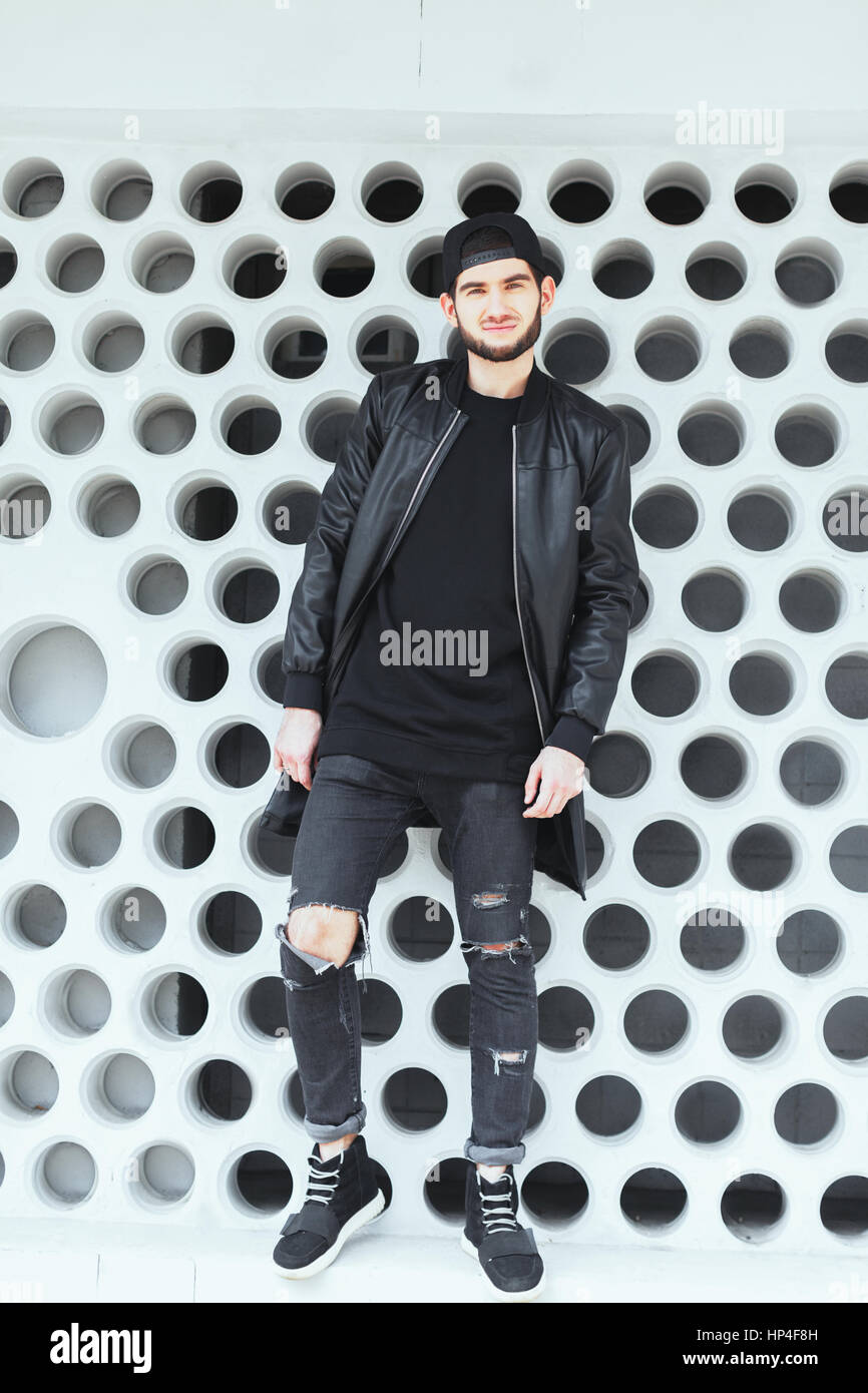 Boy standing near wall Stock Photo - Alamy
