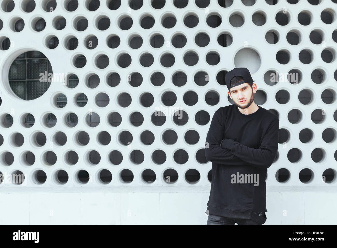 Young man near wall Stock Photo - Alamy