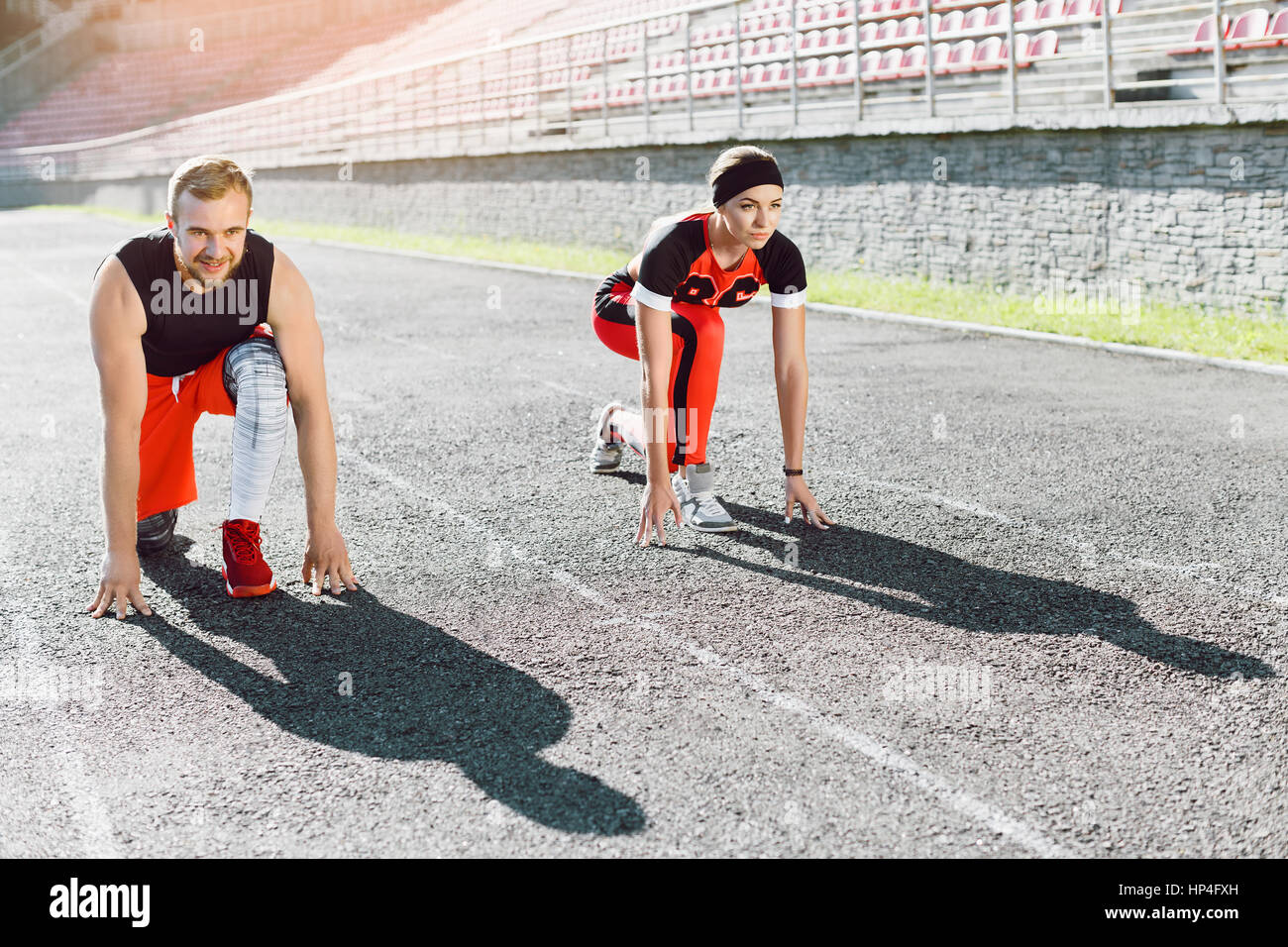 Man and woman standing on start position Stock Photo - Alamy