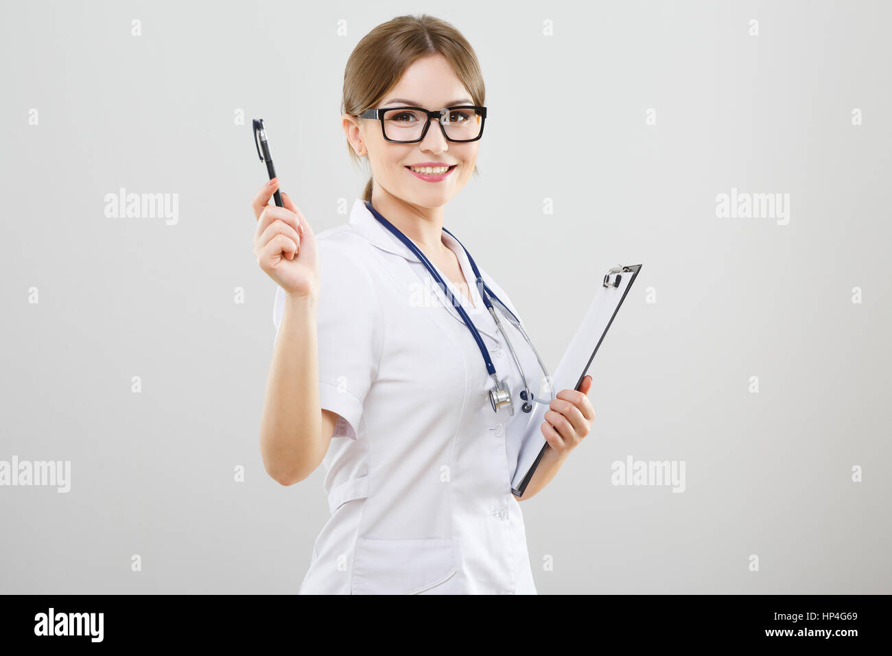 Pretty nurse at studio background Stock Photo - Alamy