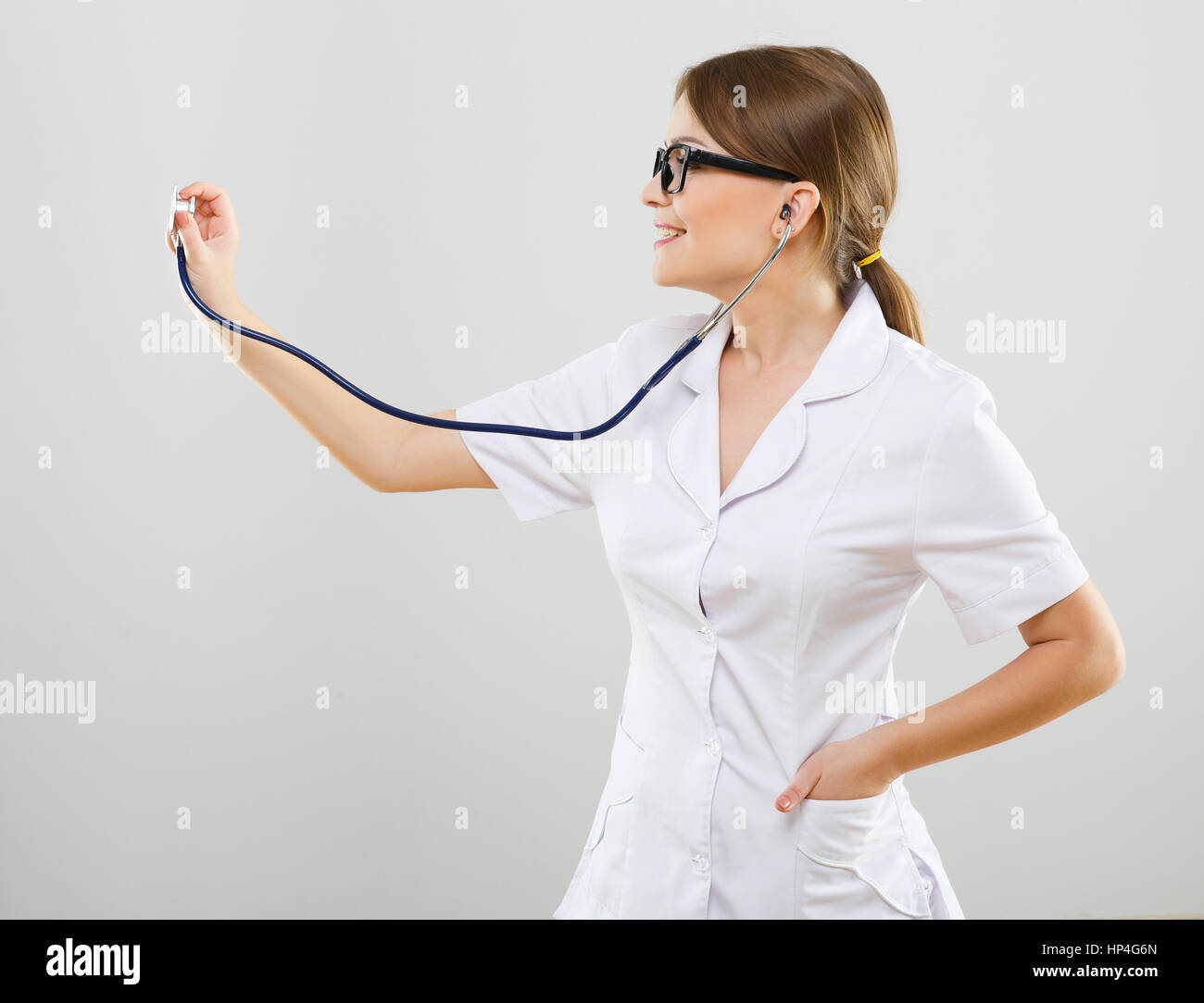 Pretty nurse at studio background Stock Photo - Alamy