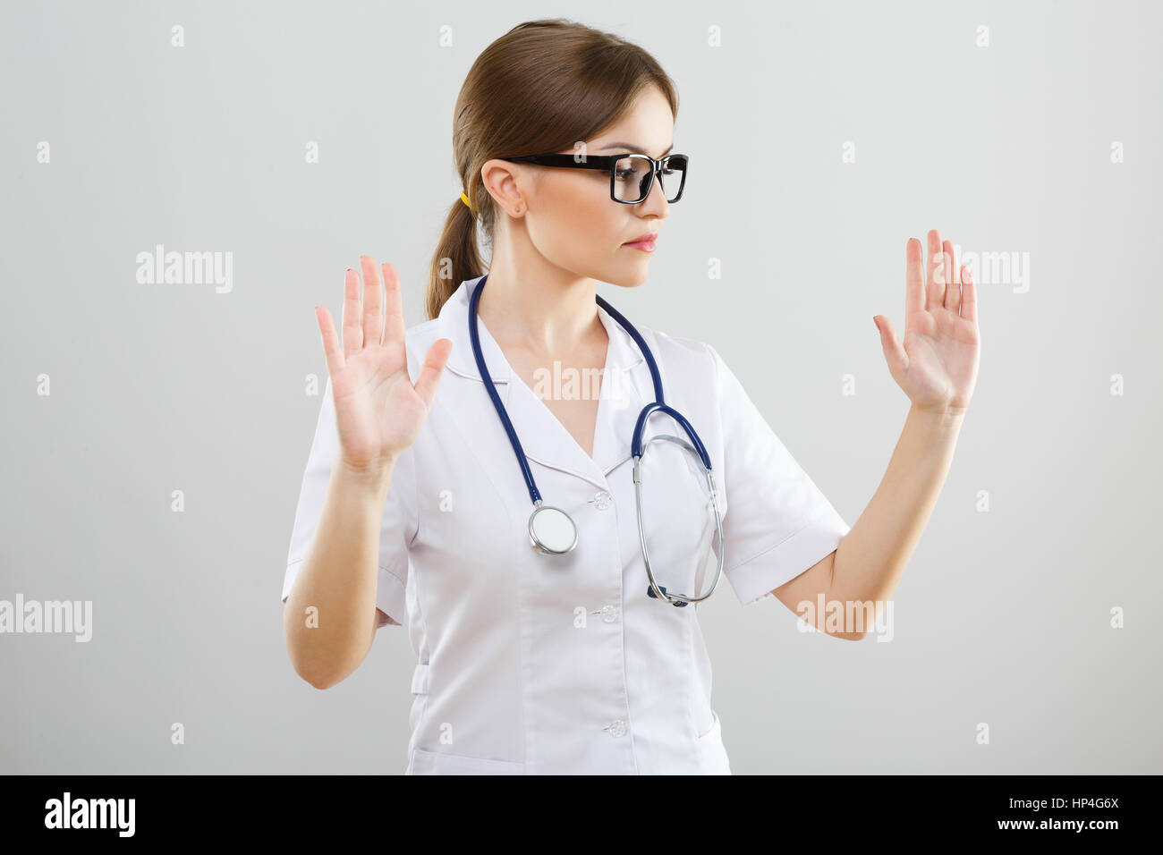 Pretty nurse at studio background Stock Photo - Alamy