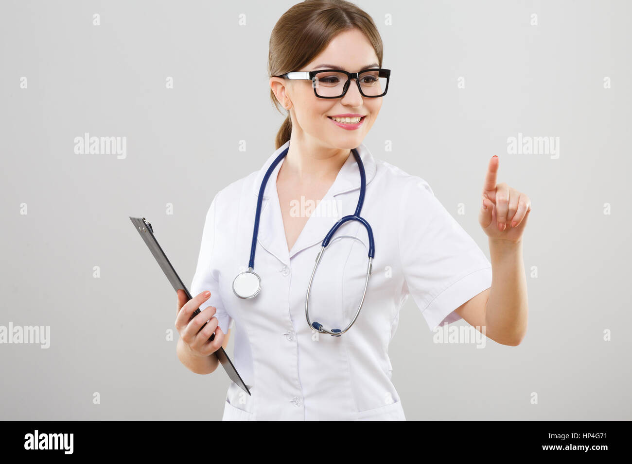 Pretty nurse at studio background Stock Photo - Alamy