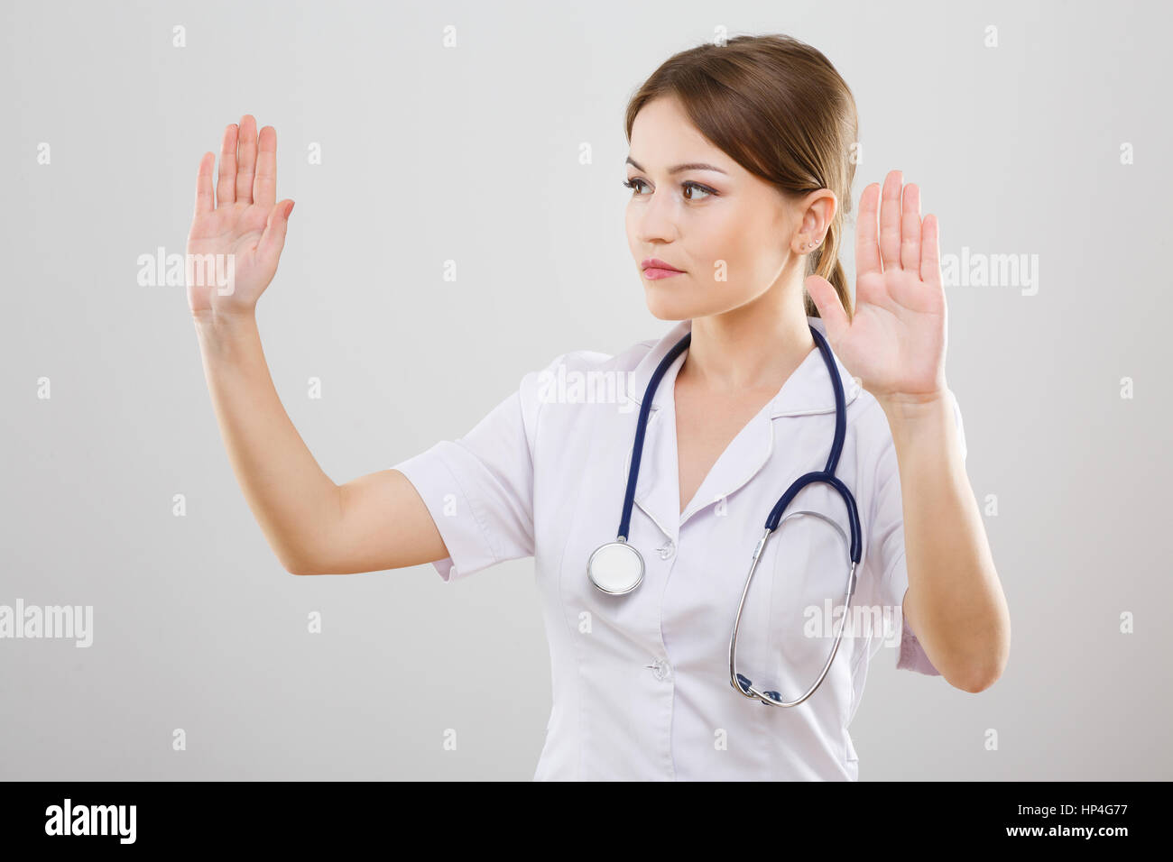 Pretty nurse at studio background Stock Photo - Alamy