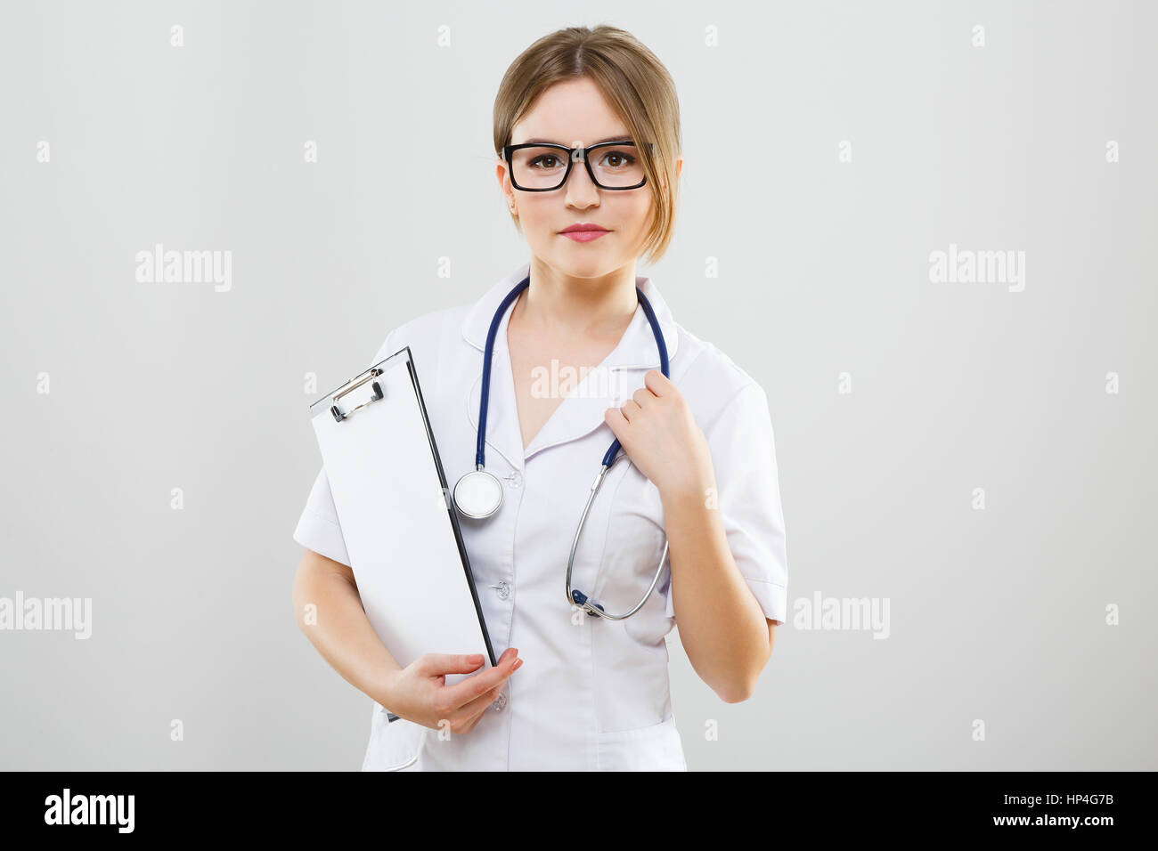 Pretty nurse at studio background Stock Photo - Alamy