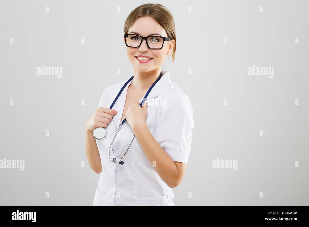 Pretty nurse at studio background Stock Photo - Alamy