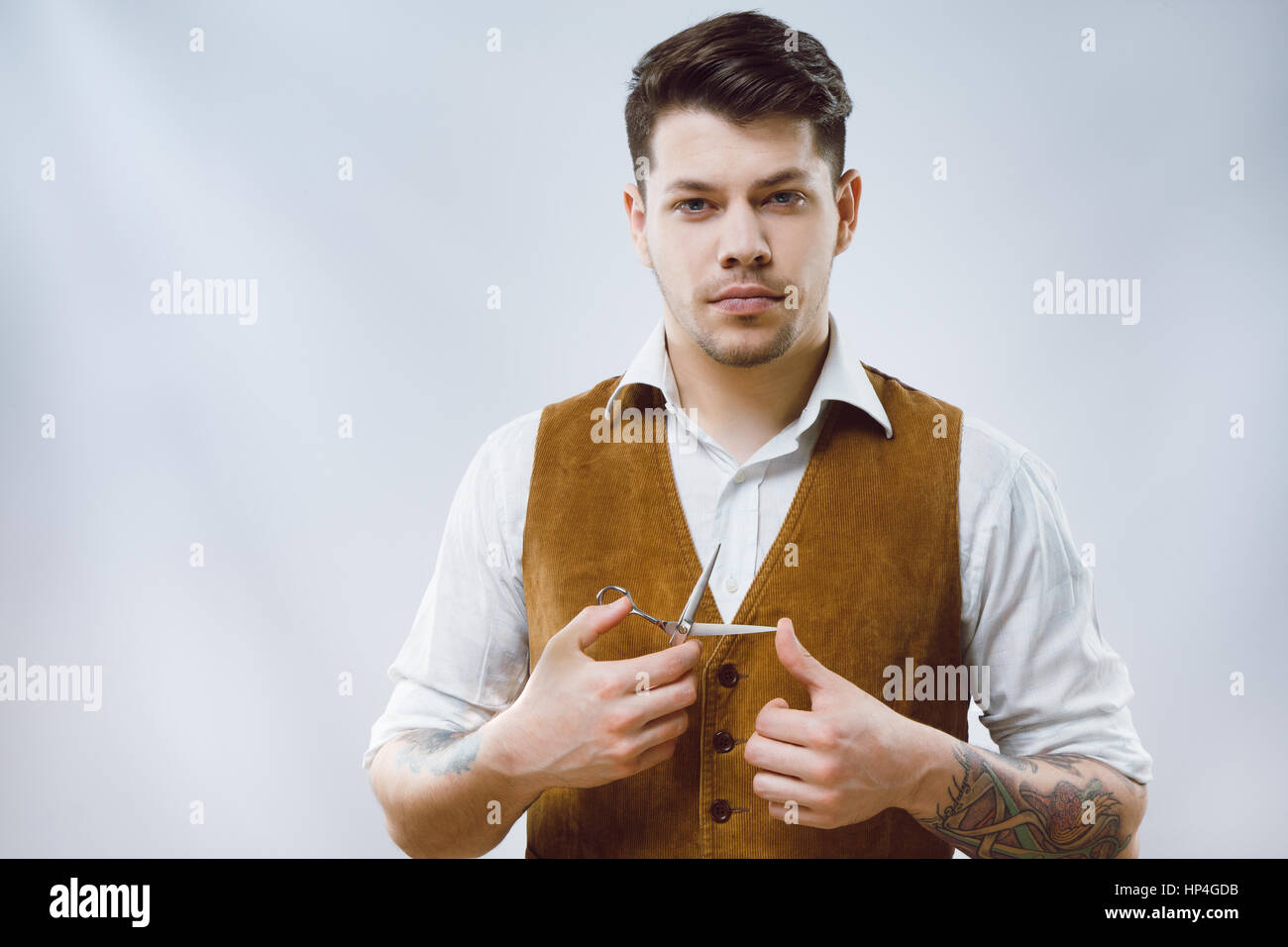 Attractive barber with scissors Stock Photo - Alamy