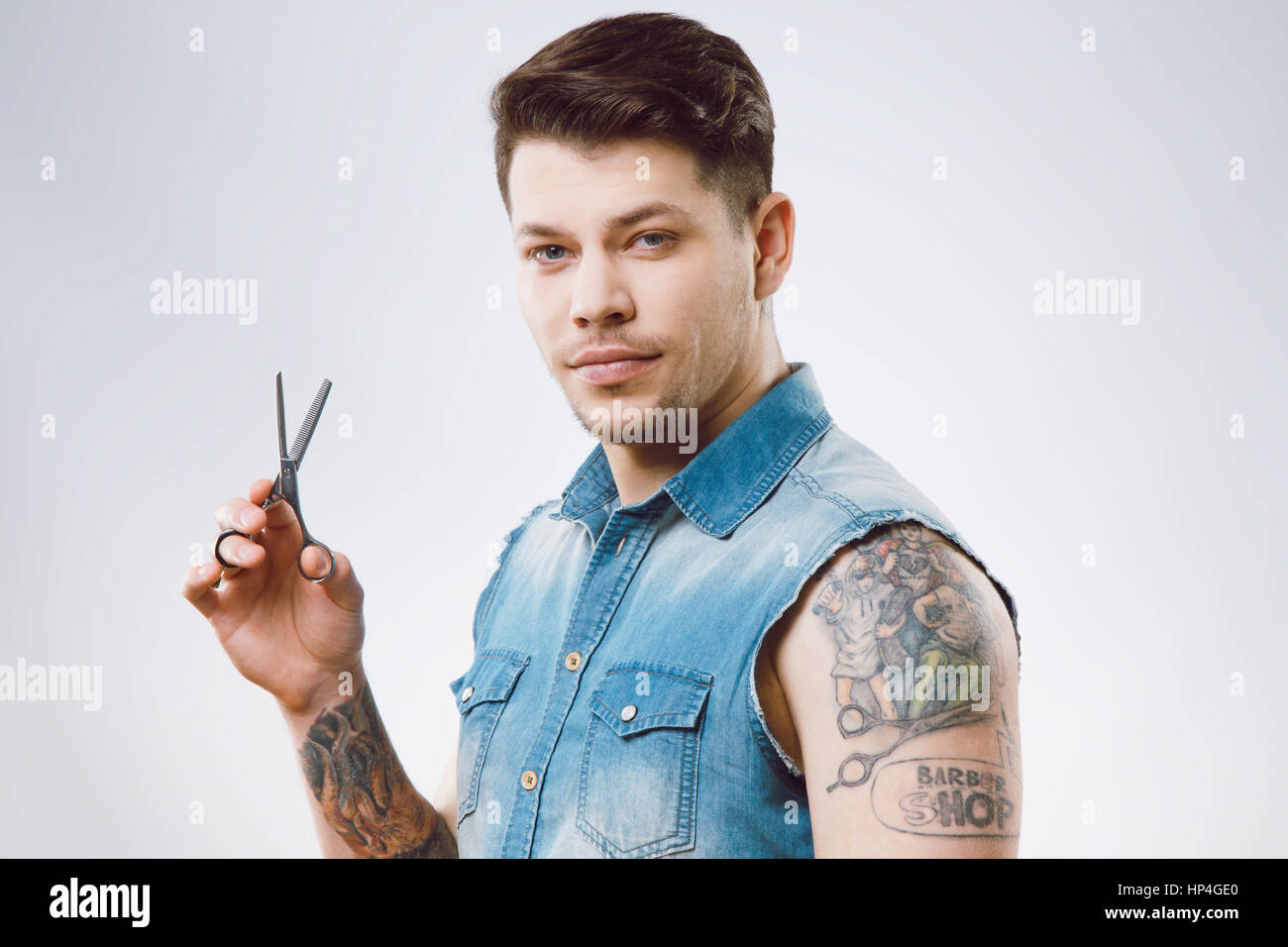 Attractive barber with scissors Stock Photo - Alamy