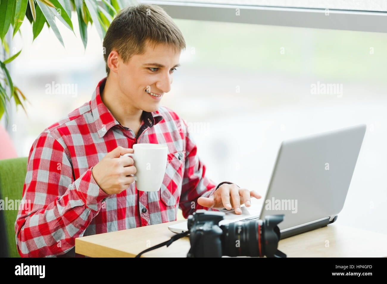 Handsome man working with laptop Stock Photo - Alamy