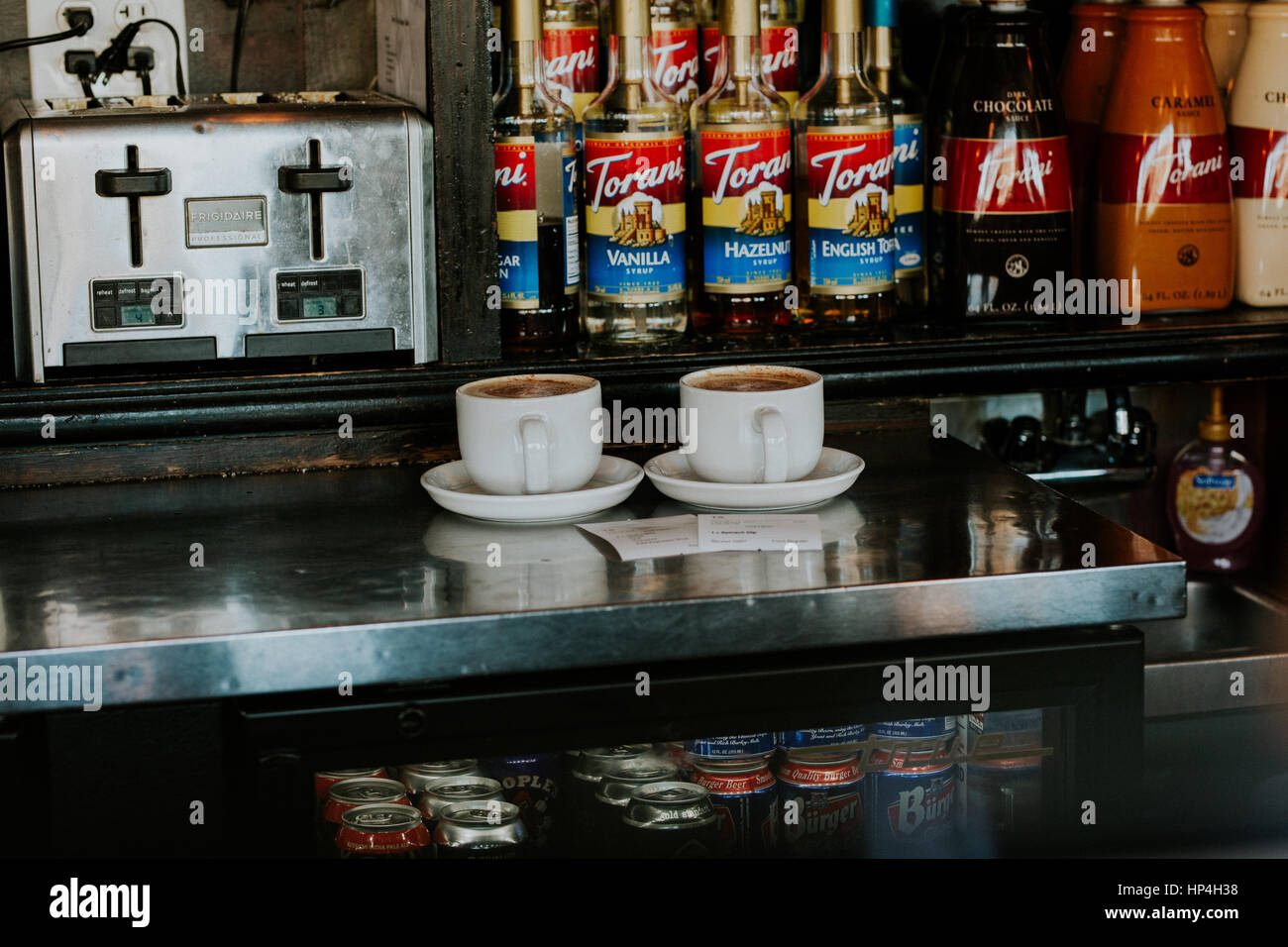 Two lattes sitting on the counter at a vintage coffee shop Stock Photo ...