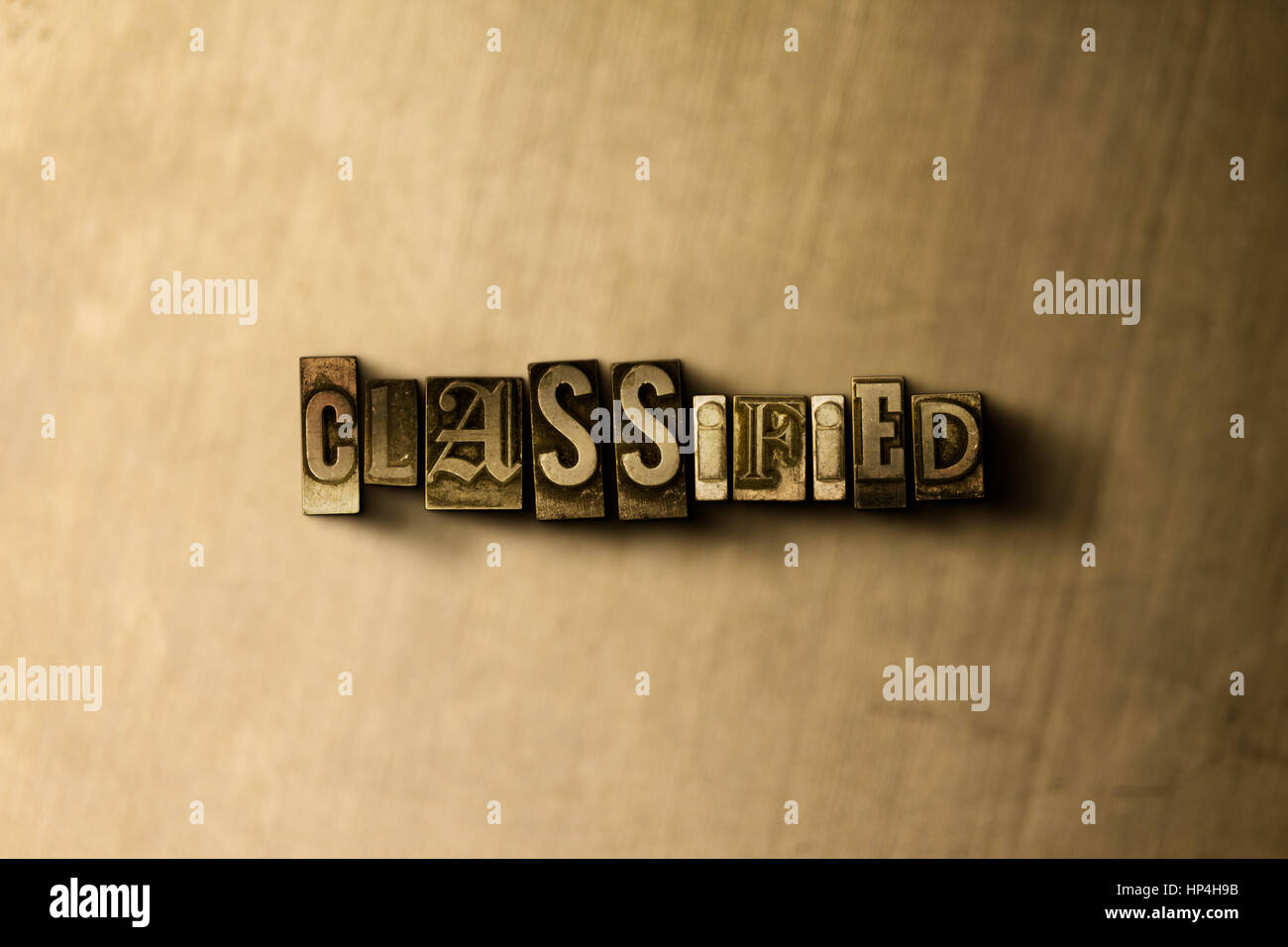CLASSIFIED - close-up of grungy vintage typeset word on metal backdrop ...