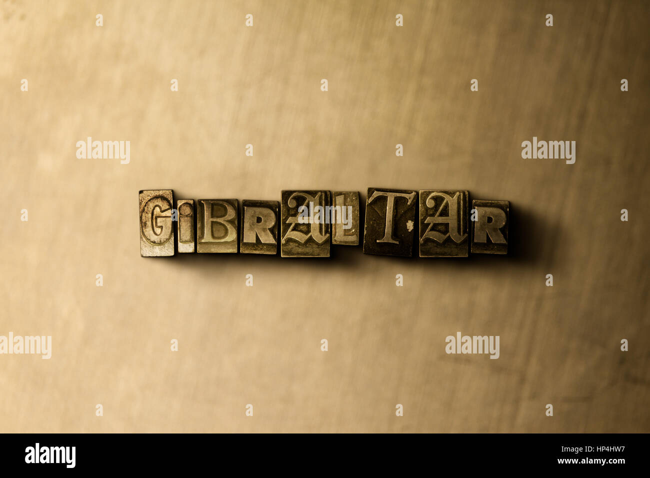 GIBRALTAR - close-up of grungy vintage typeset word on metal backdrop ...