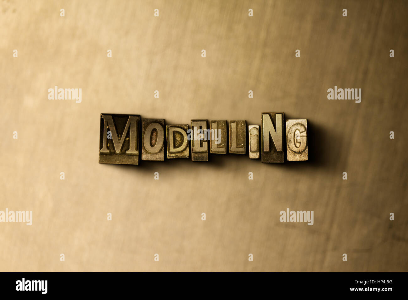 MODELLING - close-up of grungy vintage typeset word on metal backdrop ...