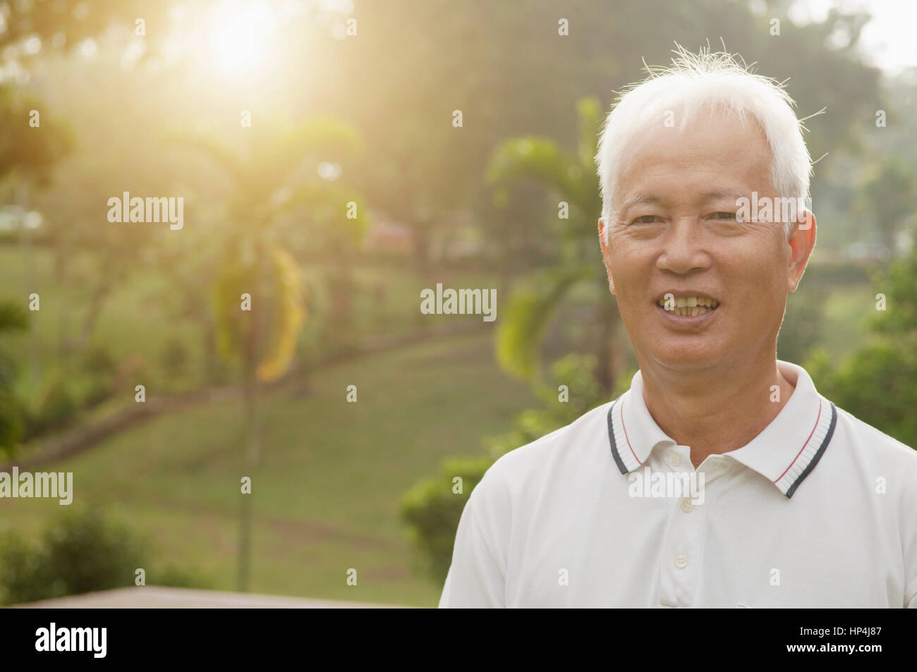 Portrait of healthy Asian senior man at outdoor nature park, morning beautiful sunlight ...