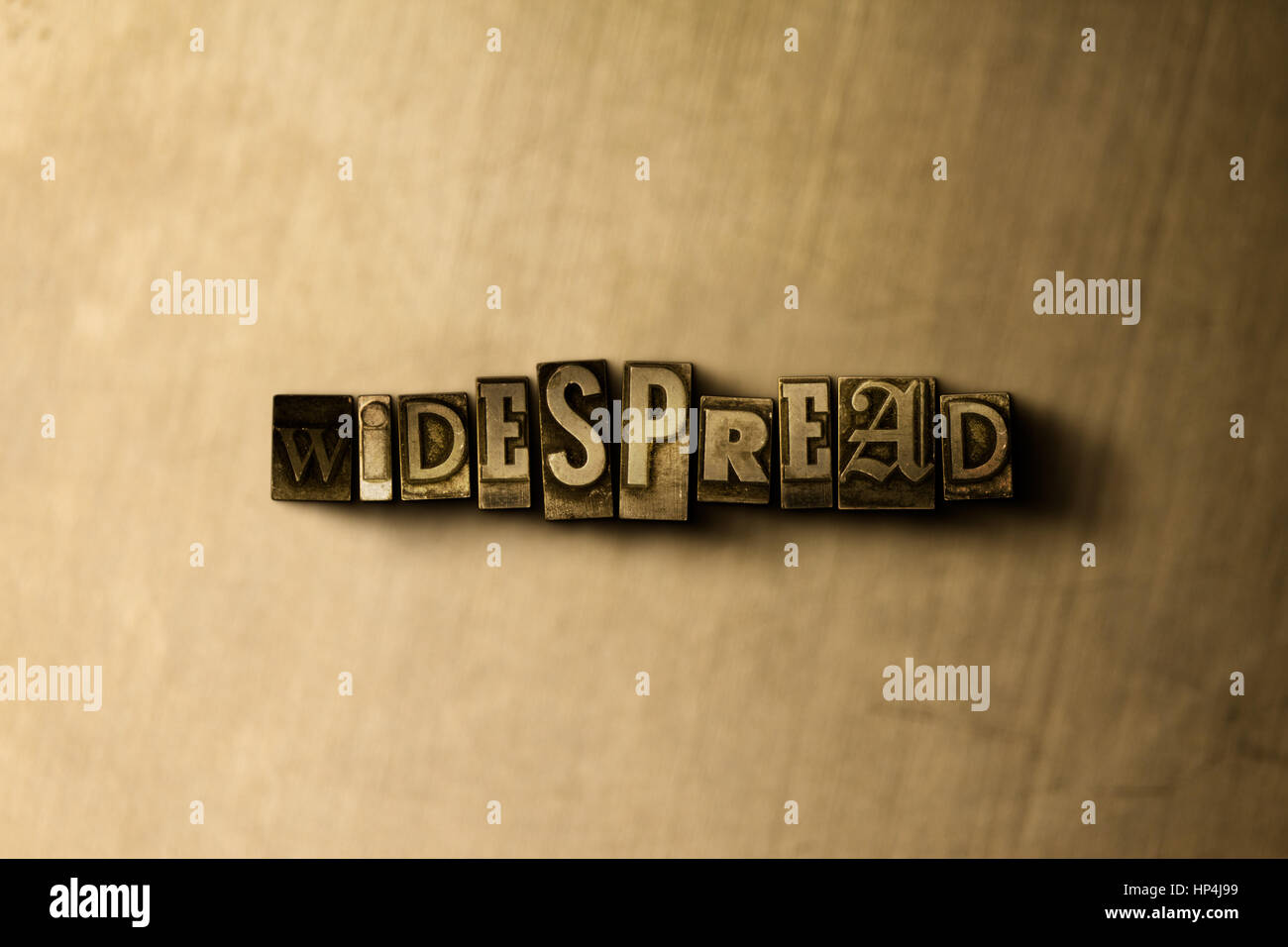 WIDESPREAD - close-up of grungy vintage typeset word on metal backdrop ...
