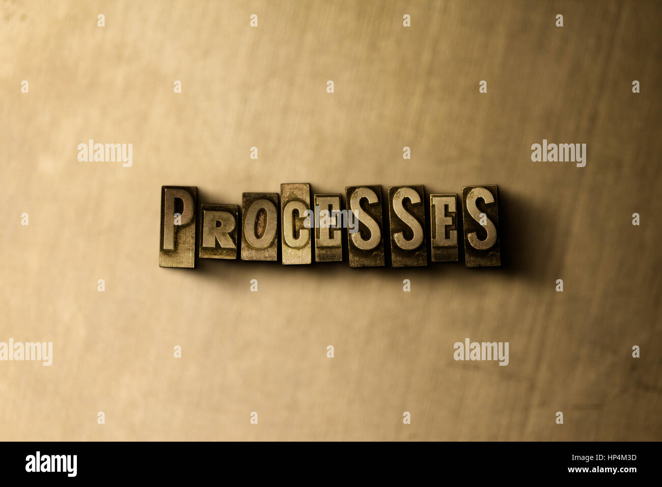 PROCESSES - close-up of grungy vintage typeset word on metal backdrop ...