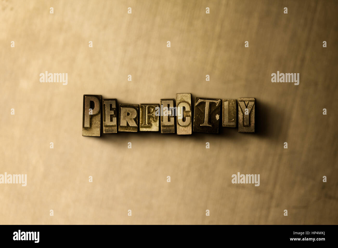 PERFECTLY - close-up of grungy vintage typeset word on metal backdrop ...