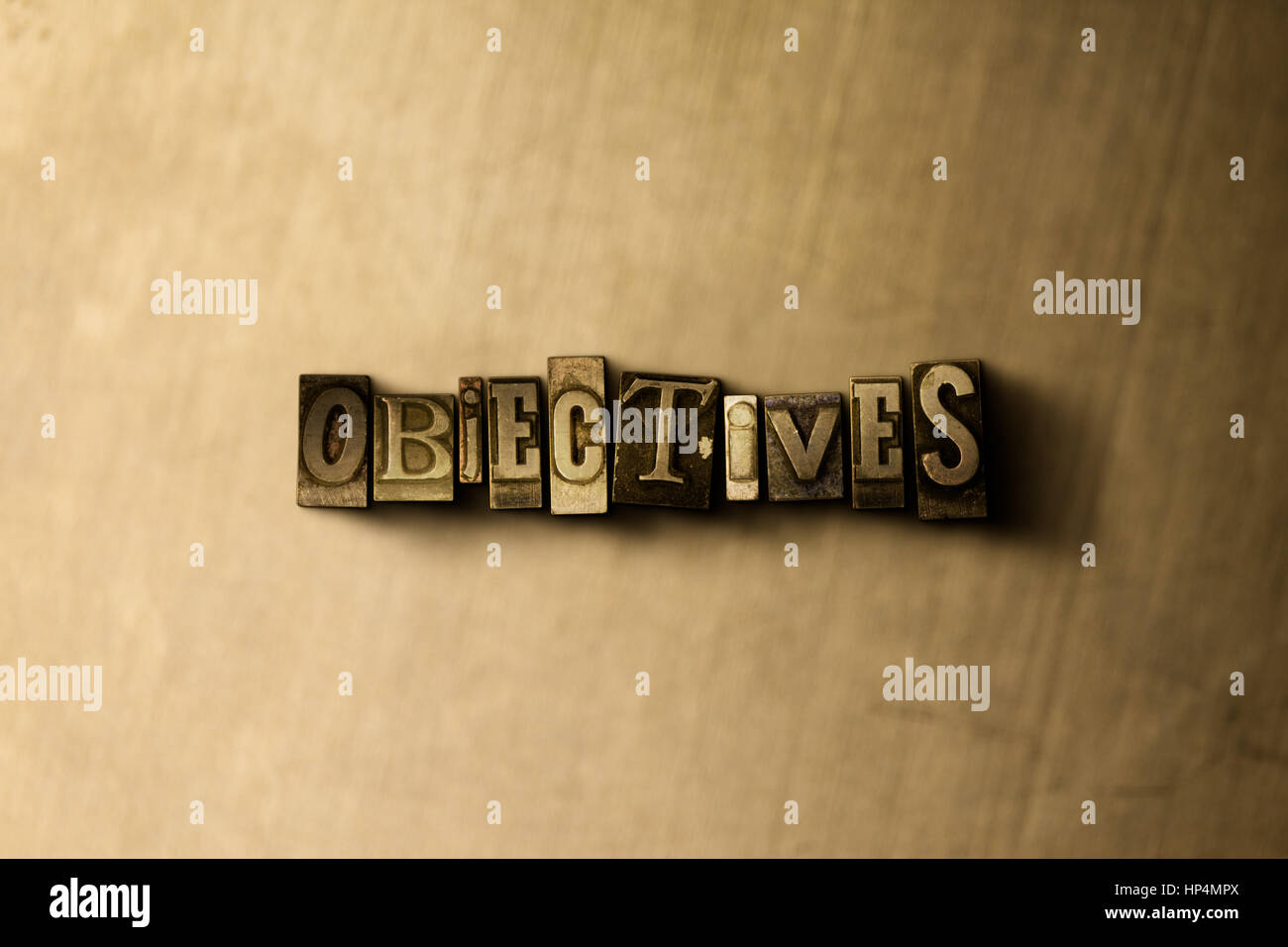 OBJECTIVES - close-up of grungy vintage typeset word on metal backdrop ...
