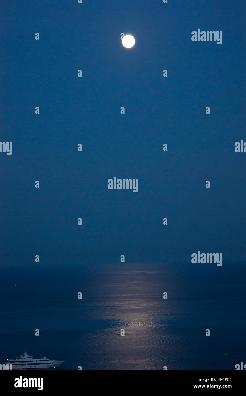 Panorama with the full moon, Mediterranean sea, and a luxury yacht, bay ...