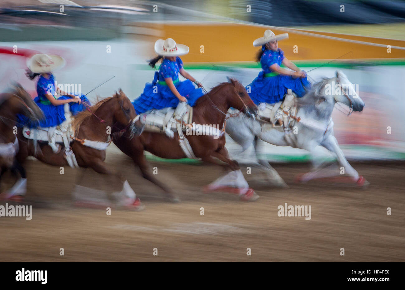 Escaramuzas ride their horses. A charreada Mexican rodeo at the Lienzo ...