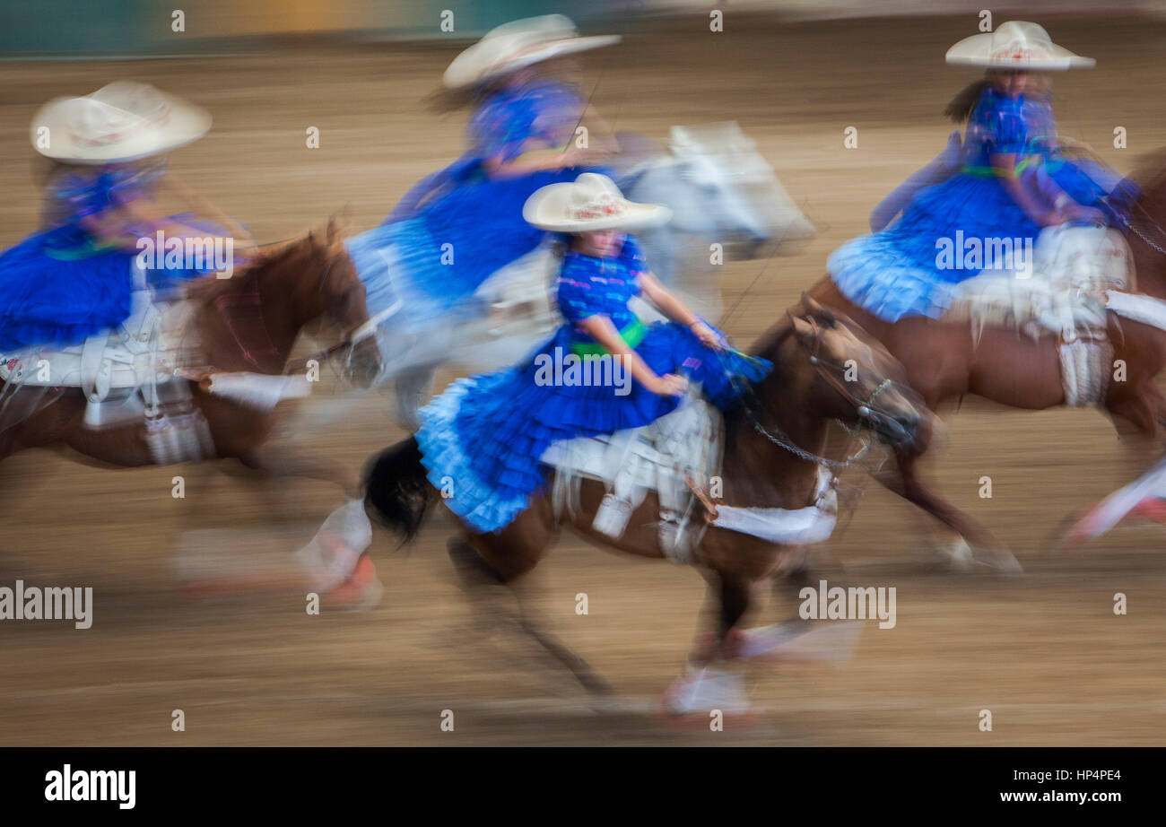 Escaramuzas ride their horses. A charreada Mexican rodeo at the Lienzo ...