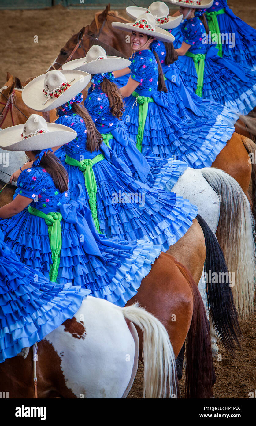 Escaramuzas ride their horses. A charreada Mexican rodeo at the Lienzo ...