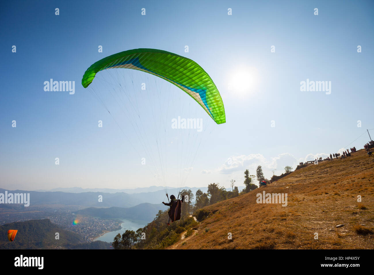 Paragliders take off from Sarangkot and fly over Pokhara, Nepal Stock ...
