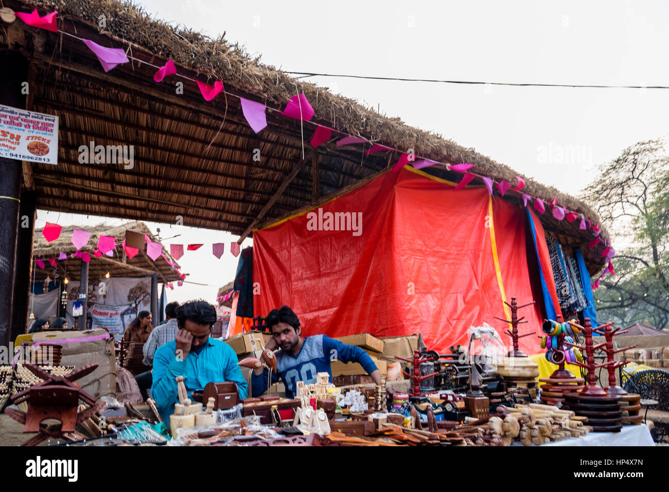 People selling handmade decorative items at a shop for sale. The crafts ...