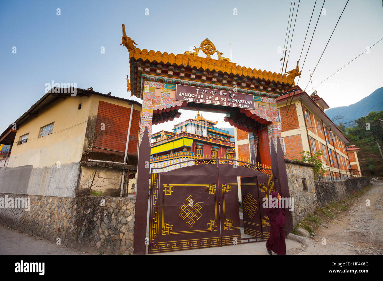 A young monk leaves the Jangchub Choeling Tibetan monastery just north ...