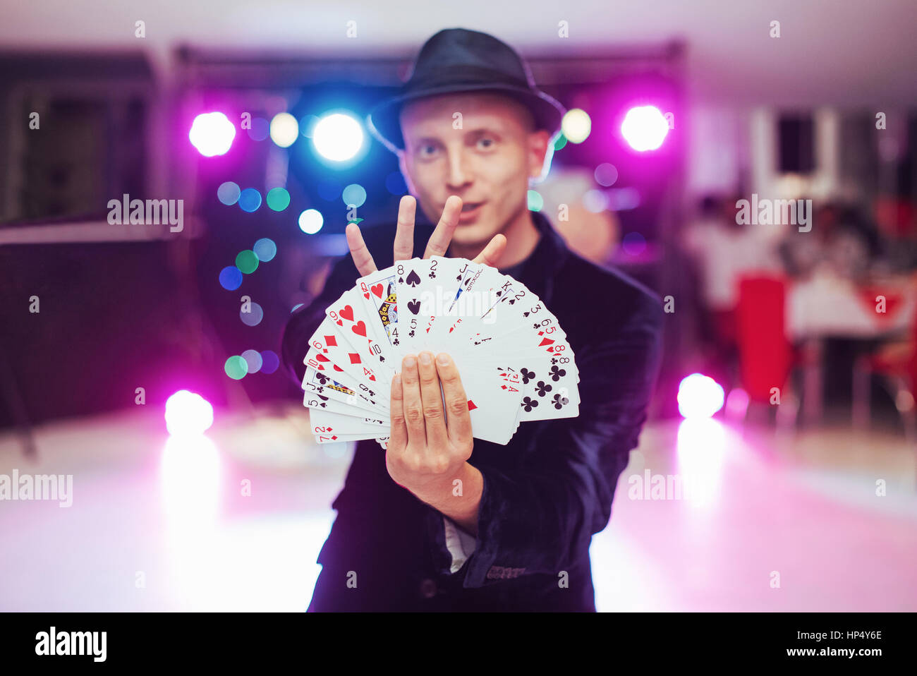 magician showing trick with playing cards Stock Photo - Alamy