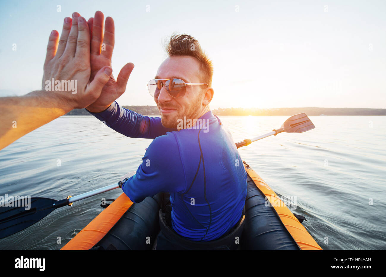 man floating on lake in a kayak at fantastic sunset Stock Photo - Alamy