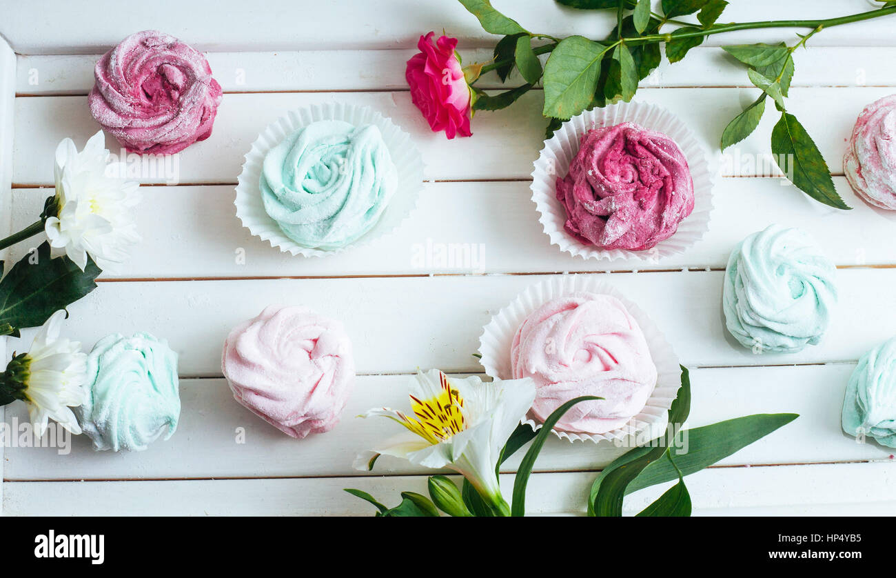 Rose marshmallows and beautiful flowers on a white background wo Stock ...