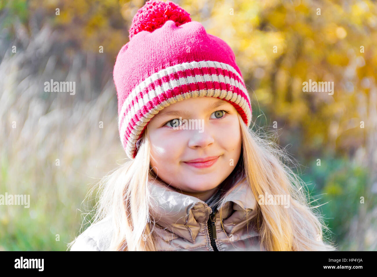 Portrait of cute smiling girl in red hat Stock Photo - Alamy