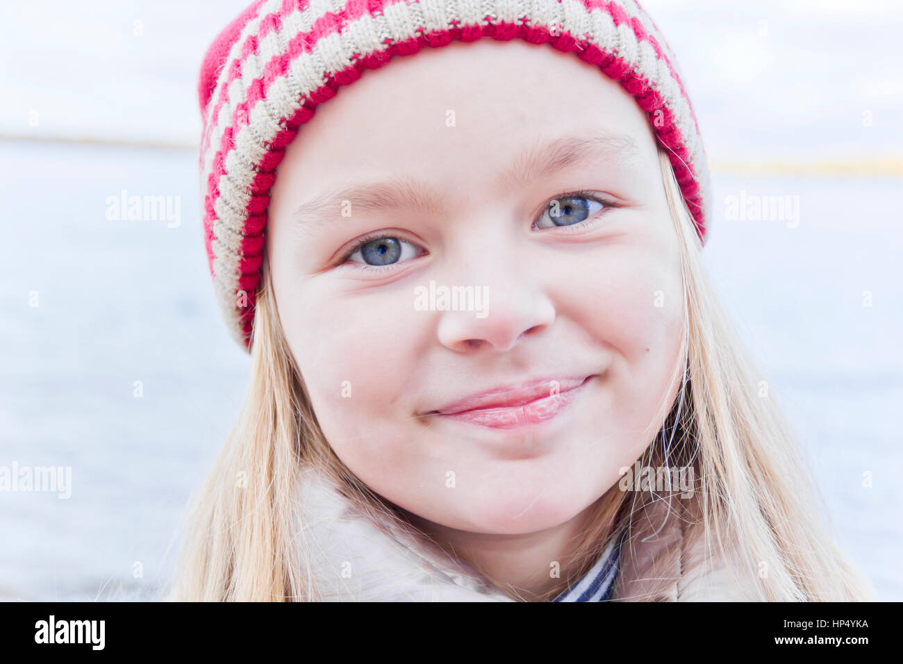 Portrait of cute smiling girl in red hat Stock Photo - Alamy