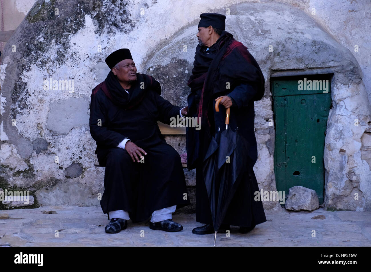Ethiopian Orthodox priests in Deir El-Sultan monastery located on roof ...