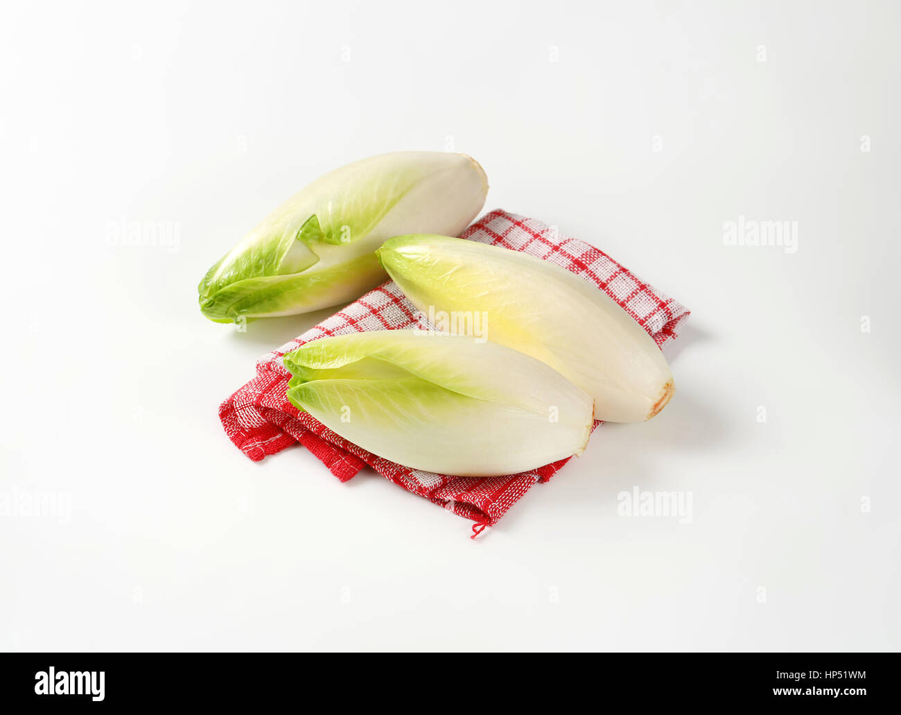 heads of fresh belgian endive on checkered dishtowel Stock Photo - Alamy