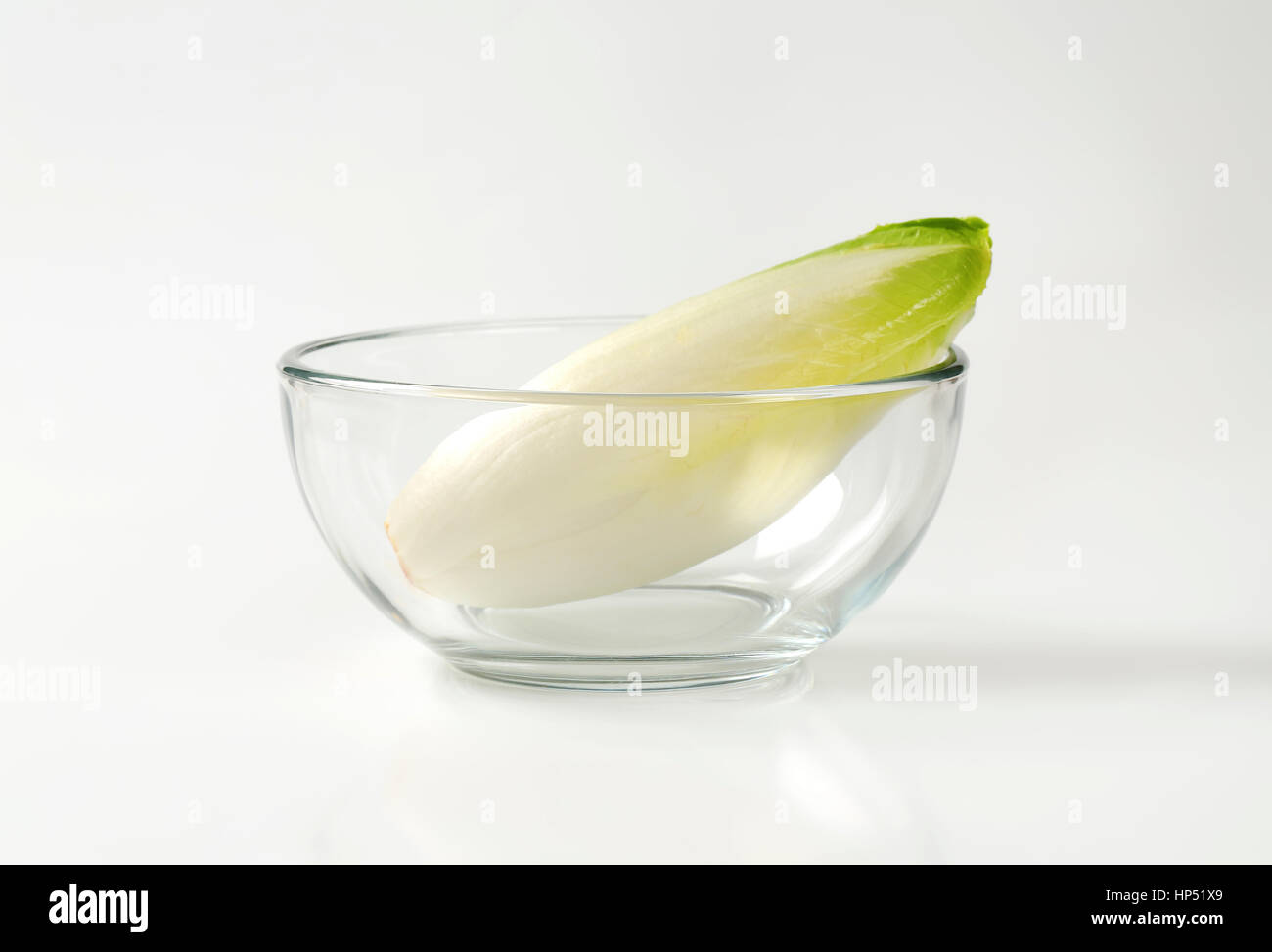 head of fresh belgian endive in glass bowl Stock Photo - Alamy