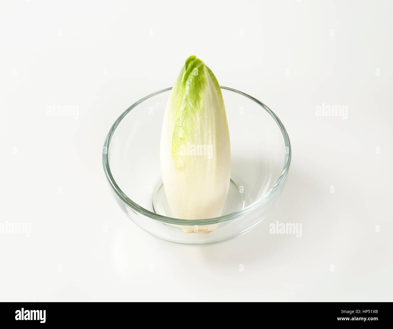 head of fresh belgian endive in glass bowl Stock Photo - Alamy