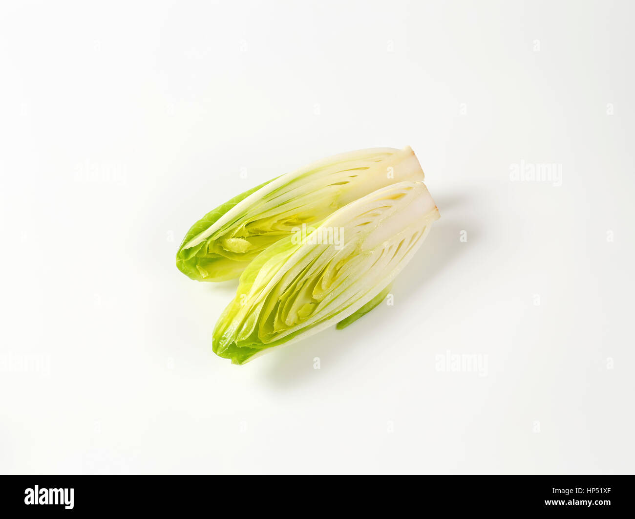 halved head of fresh belgian endive on white background Stock Photo - Alamy