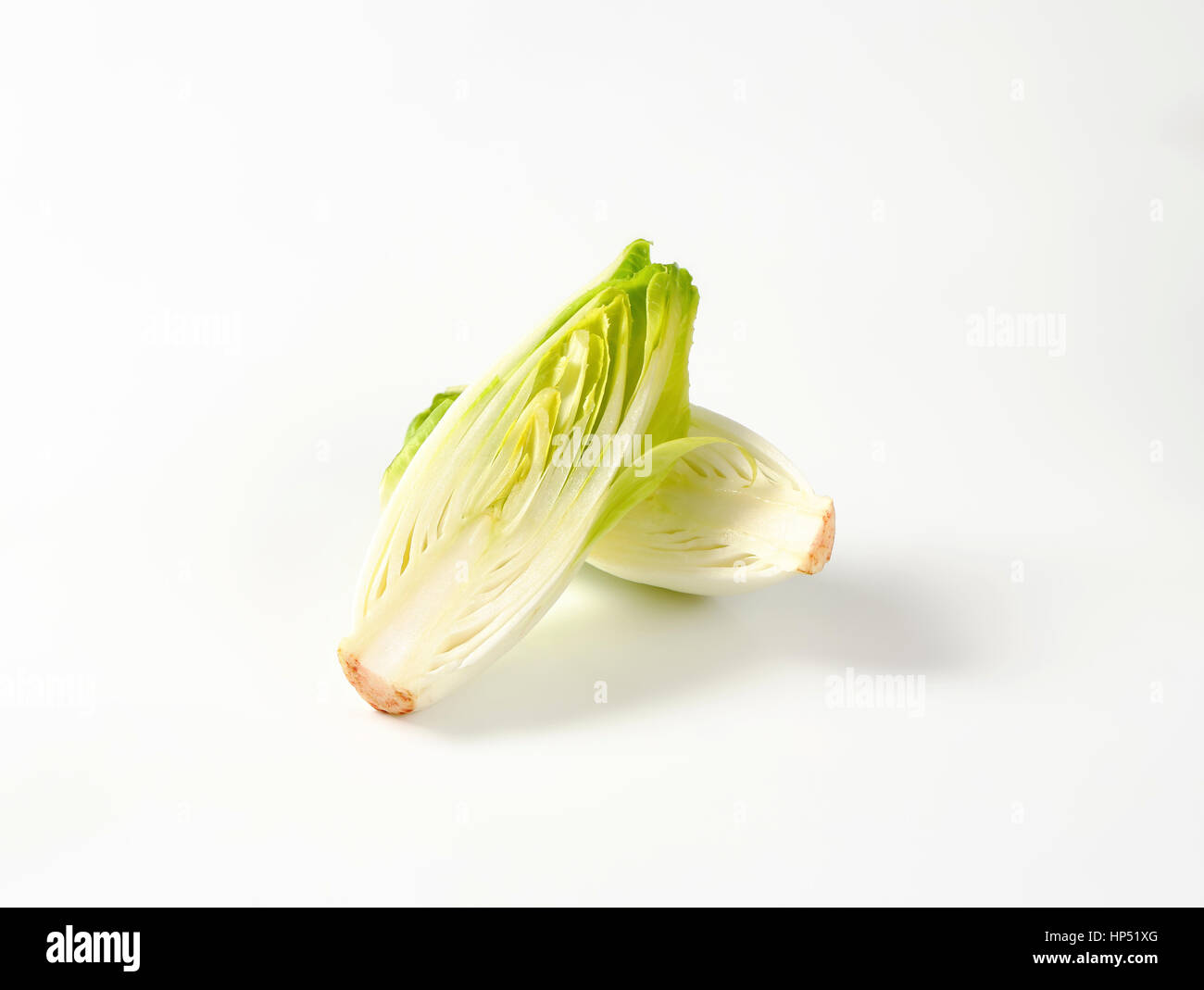 halved head of fresh belgian endive on white background Stock Photo - Alamy