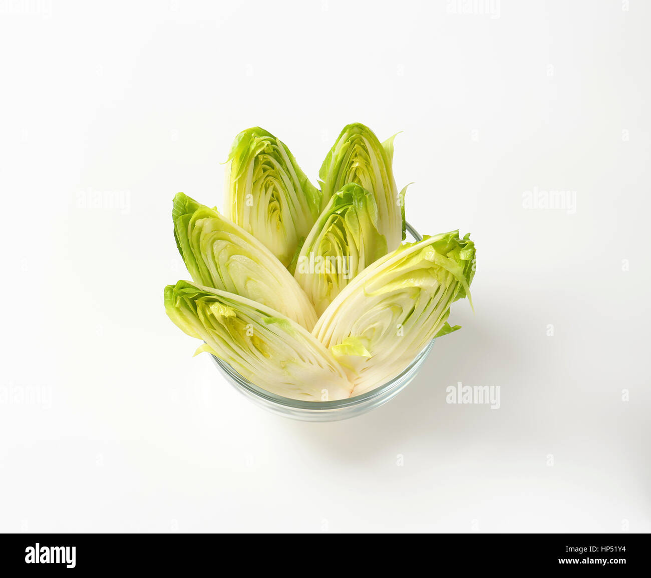 halved heads of fresh belgian endive in glass bowl Stock Photo - Alamy