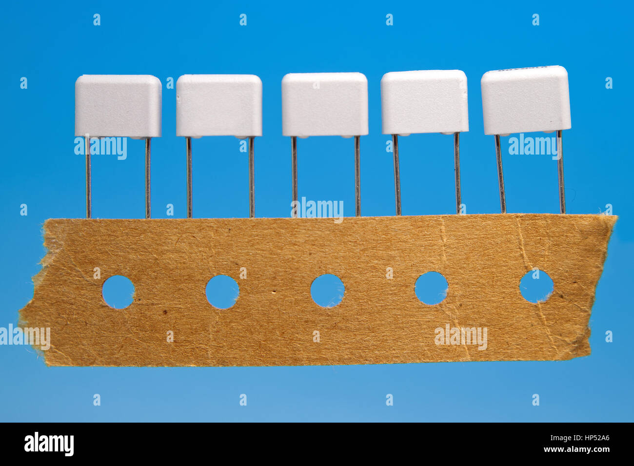 Thru hole mounting capacitors on a blue background Stock Photo - Alamy