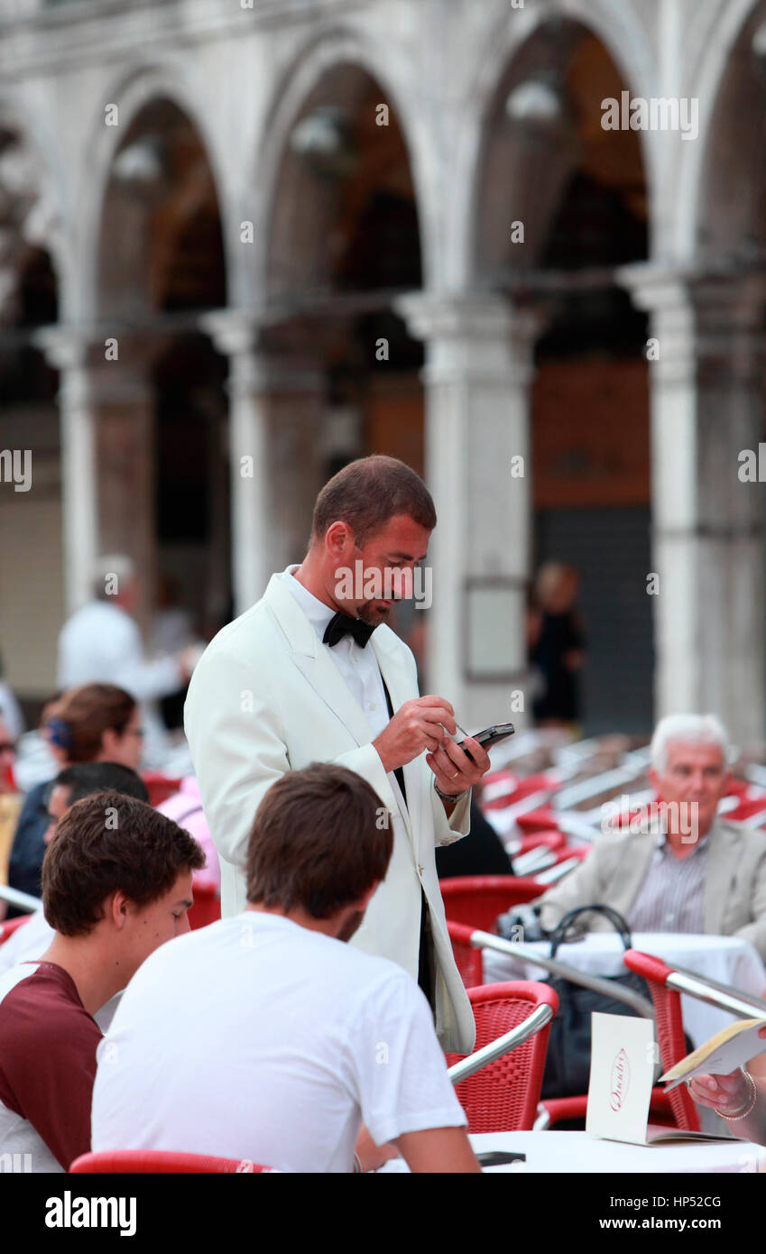 Venice,Italy,July 30th 2011: A waiter takes order of guests using a ...
