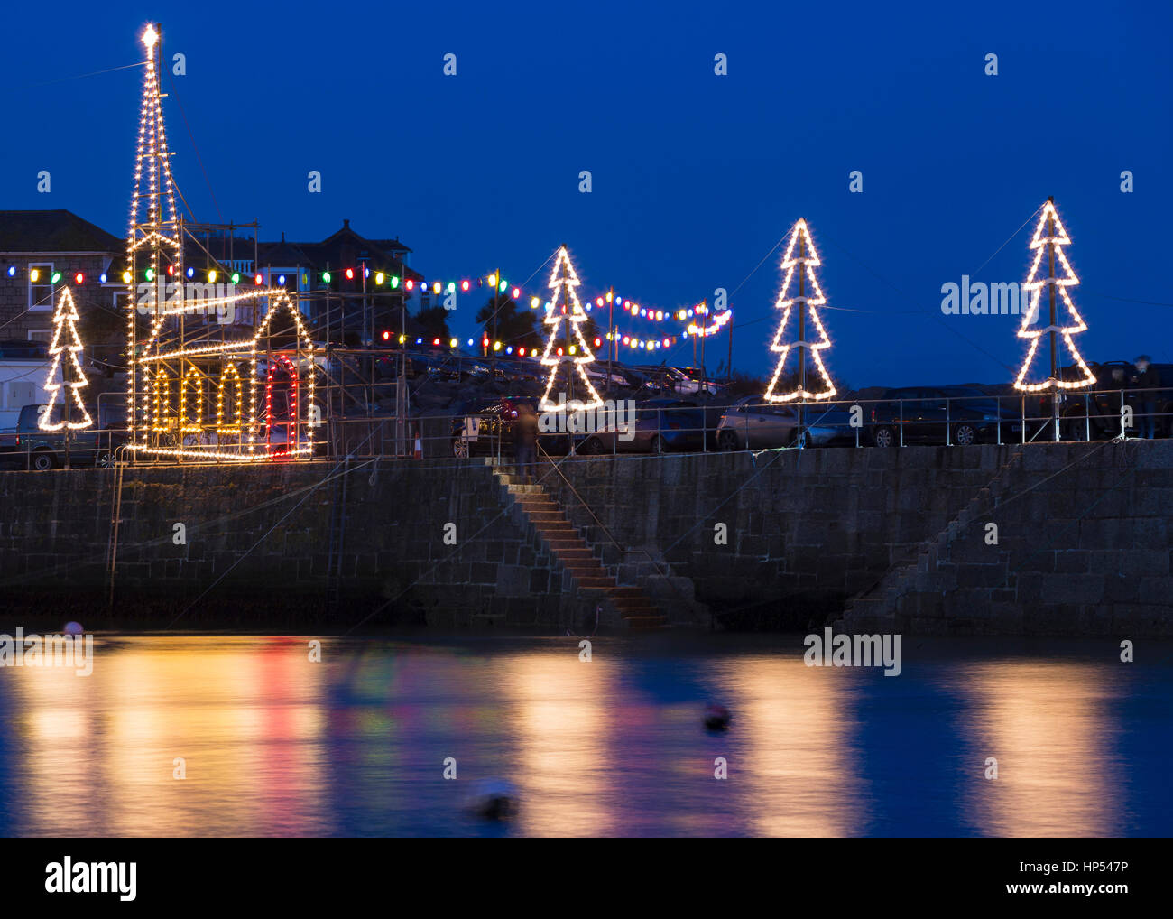 Church and Christmas lights, Mousehole Harbour, Cornwall, England, UK ...