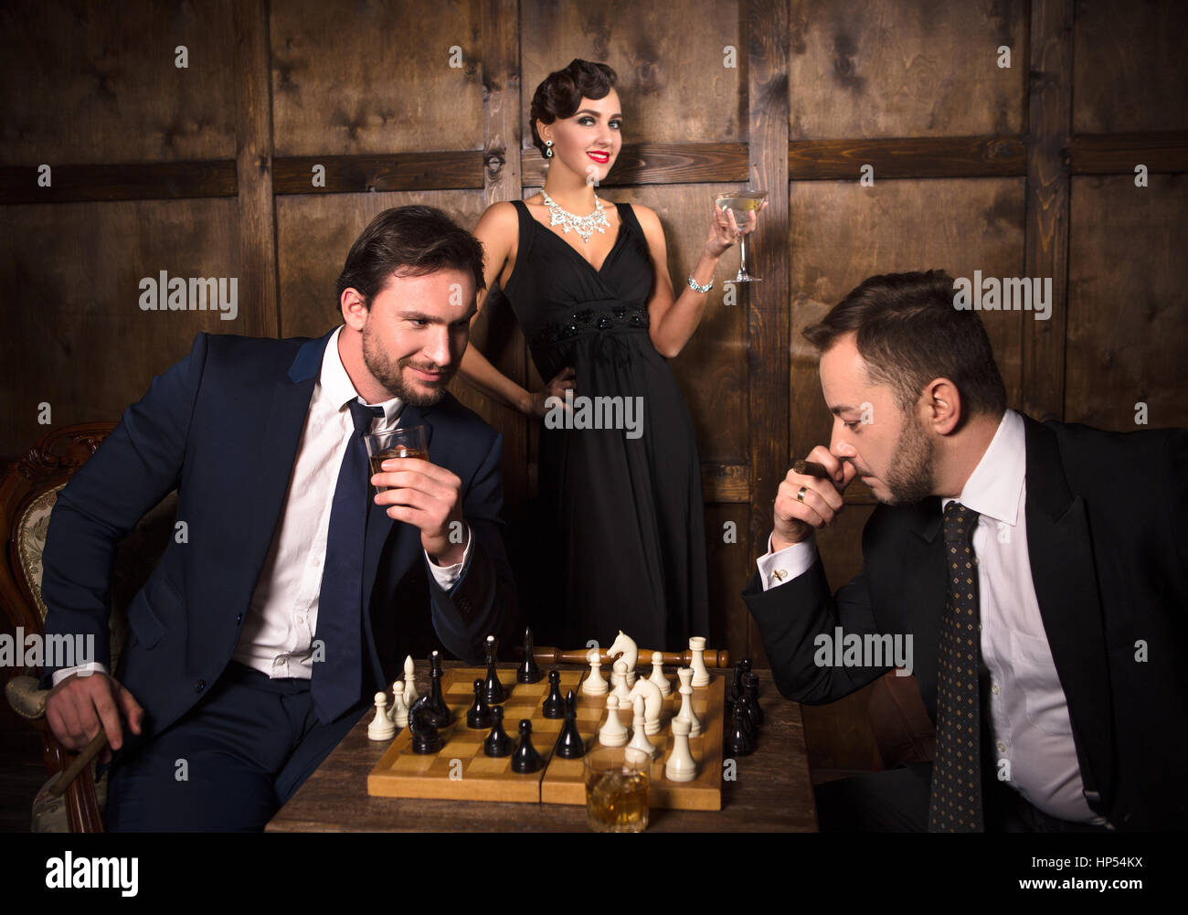Rich businessmen playing chess Stock Photo - Alamy