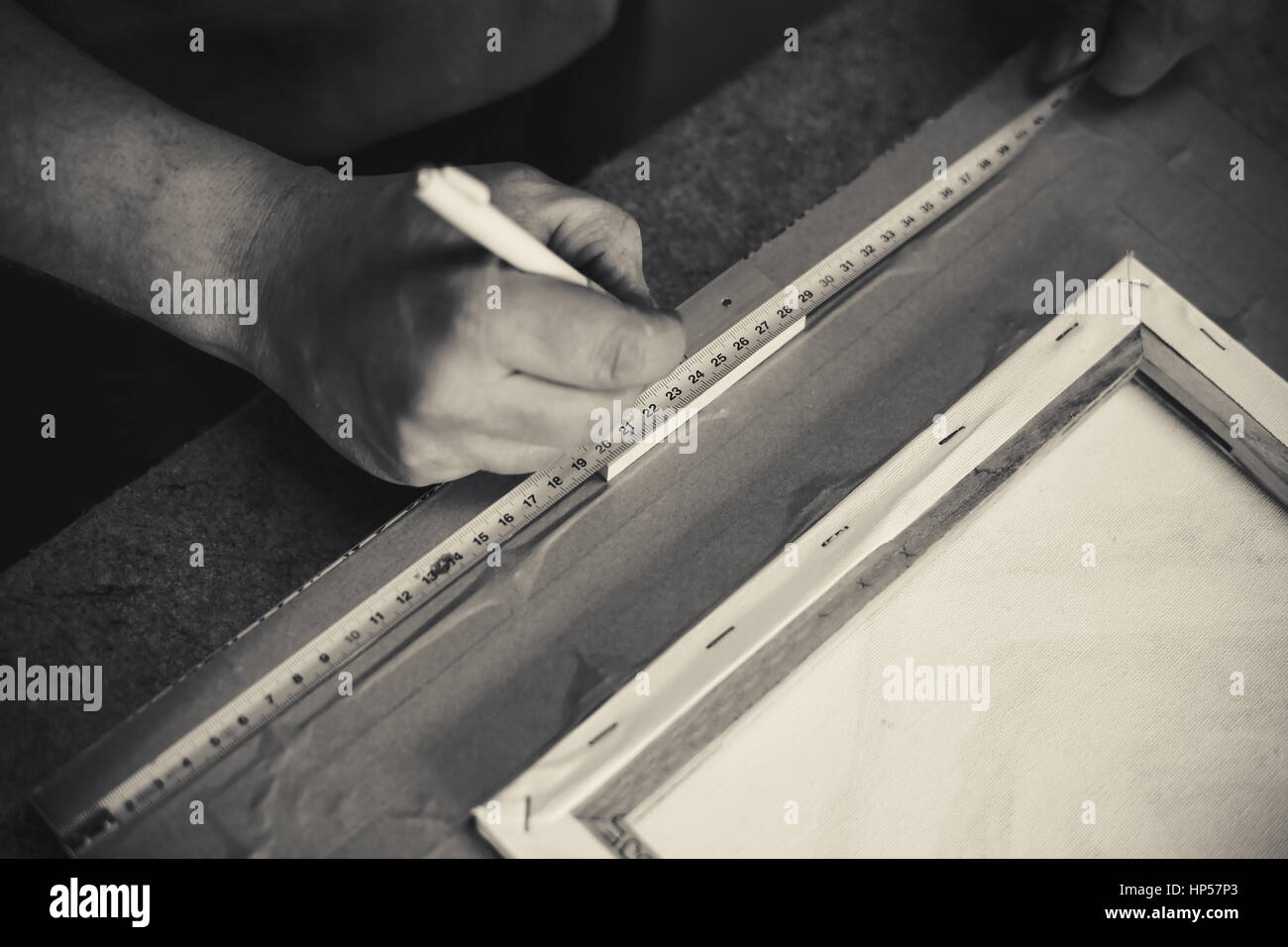 Framing the pictures, details of a craftsmen job Stock Photo - Alamy