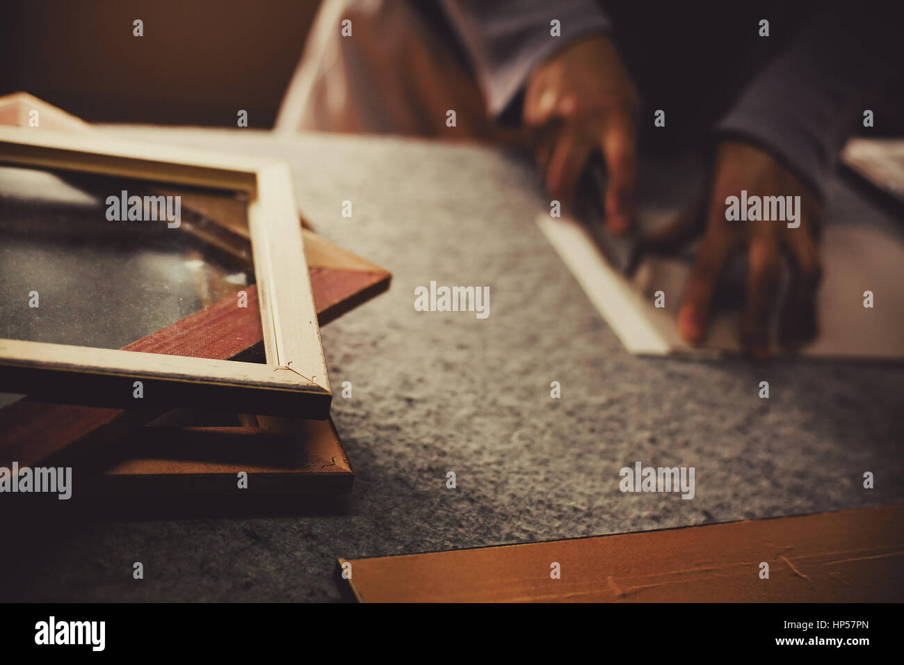 Framing the pictures, details of a craftsmen job Stock Photo - Alamy