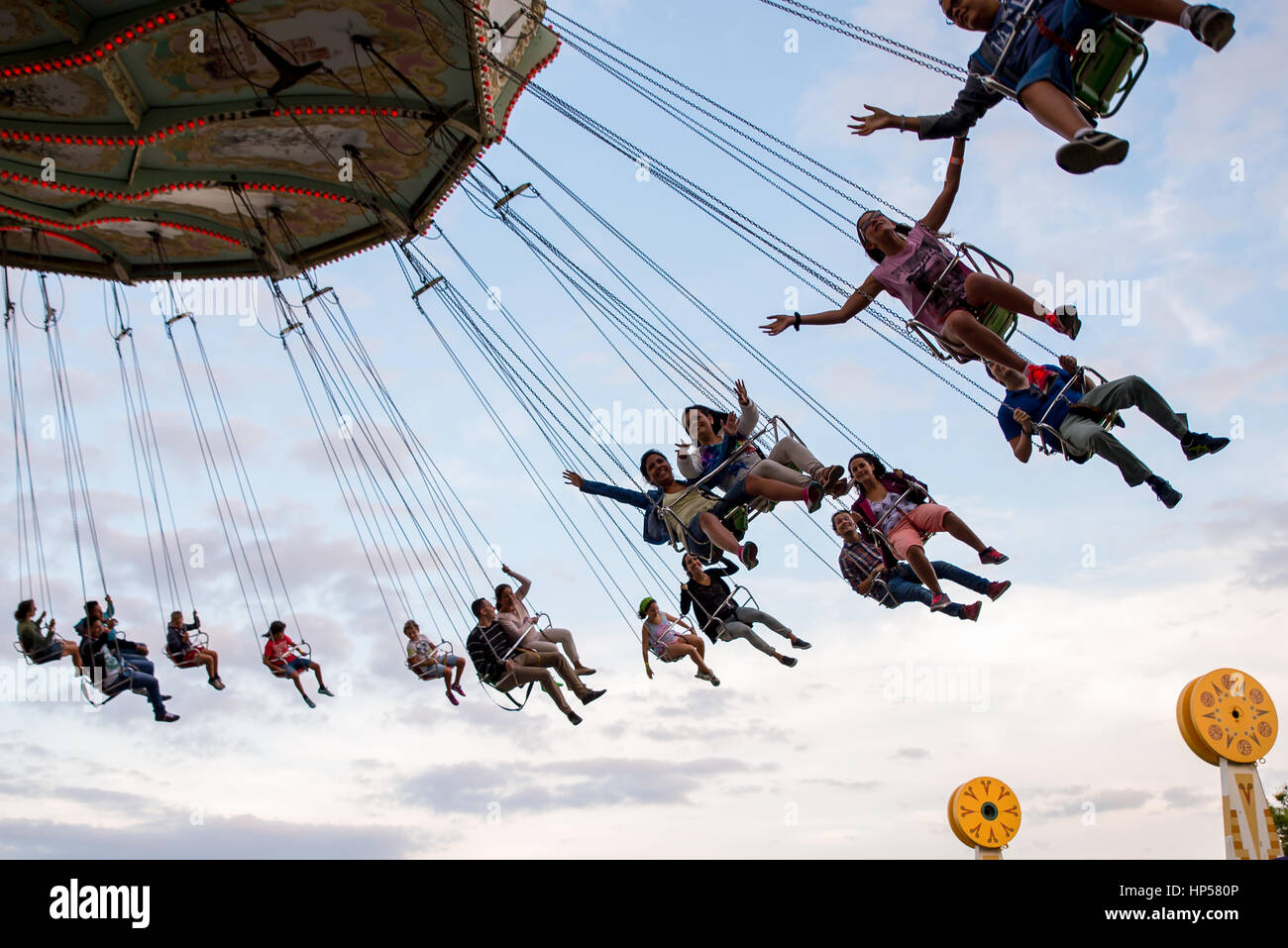 BARCELONA - SEP 5: People have fun at the carousel flying swing ride ...