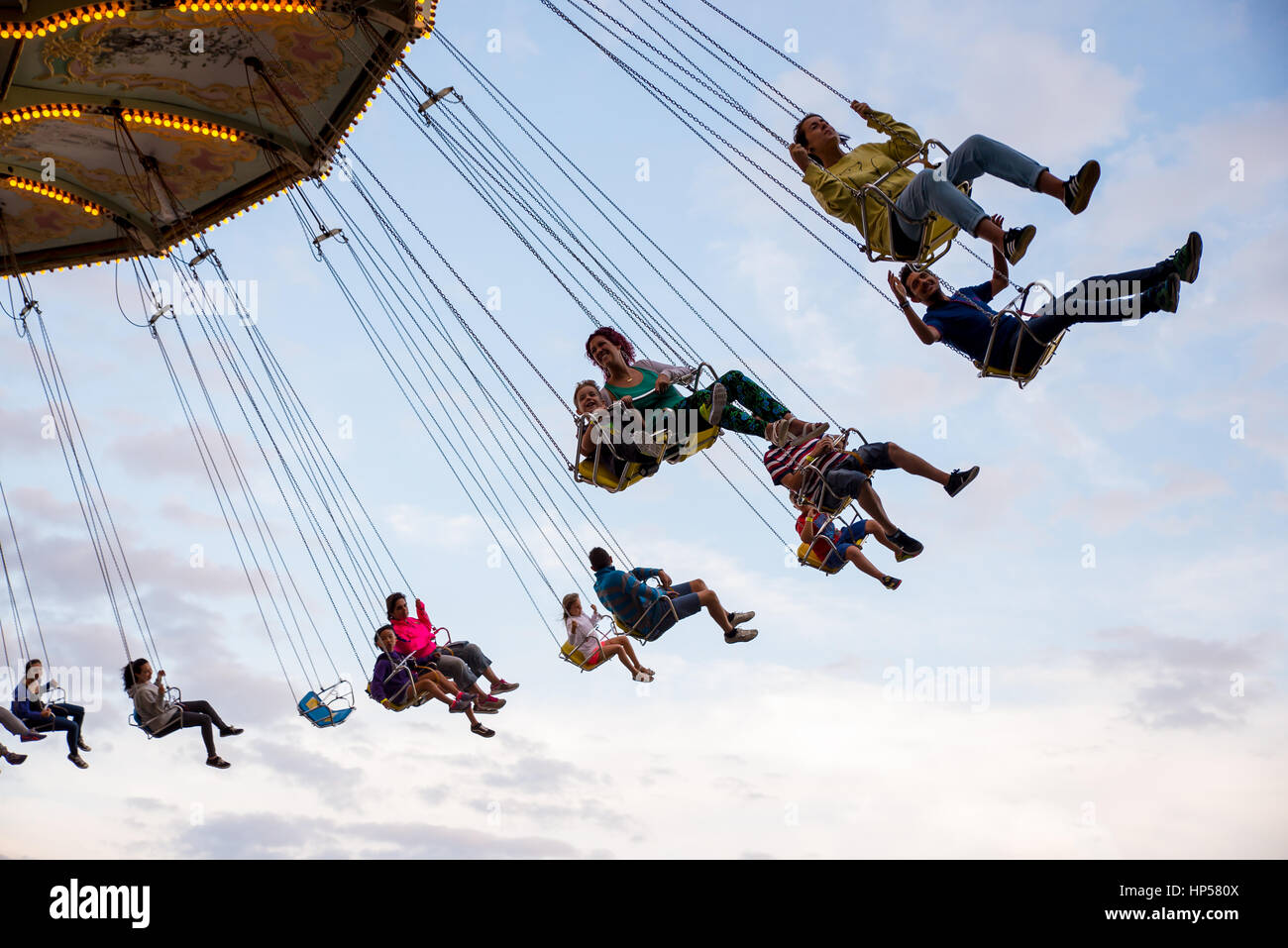BARCELONA - SEP 5: People have fun at the carousel flying swing ride ...