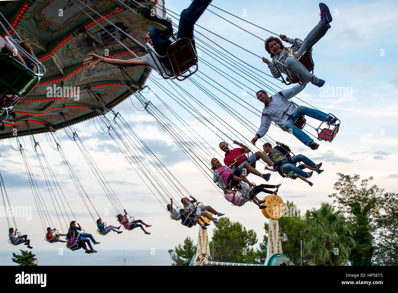 BARCELONA - SEP 5: People have fun at the carousel flying swing ride ...